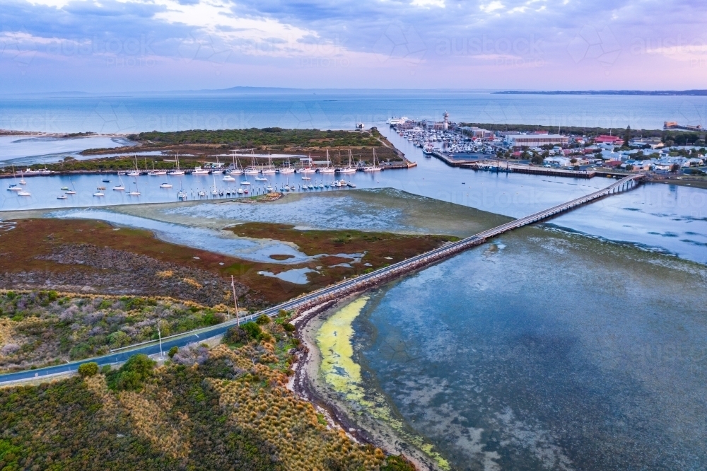 Image of Aerial view of a narrow bridge over a shallow coastal bay at ...