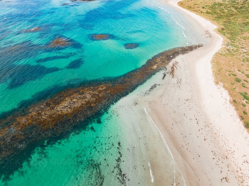 Image of Aerial view of a pointed rocky reef between turquoise blue ...
