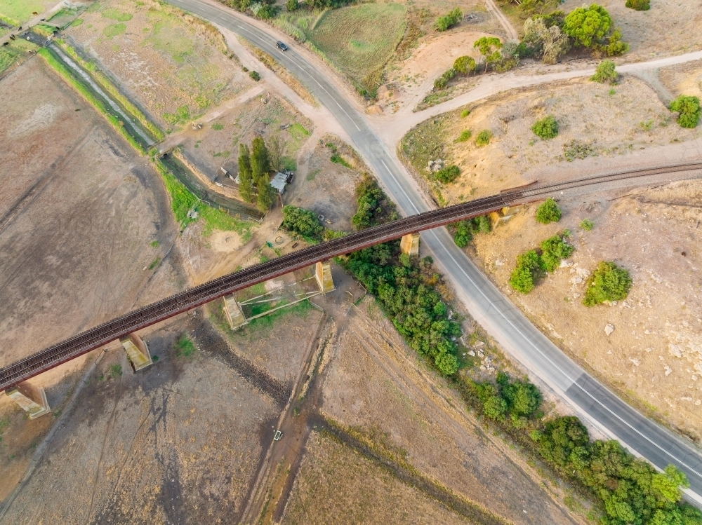 Image of Aerial view of a rail bridge crossing over farmland and ...