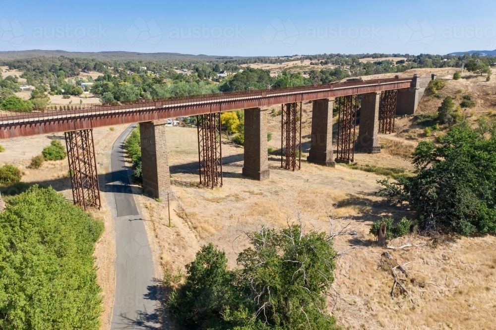 Image of Aerial view of a railway viaduct over a country road ...