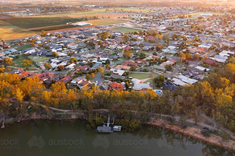 Image of Aerial view of a regional town spread out along the side of a ...