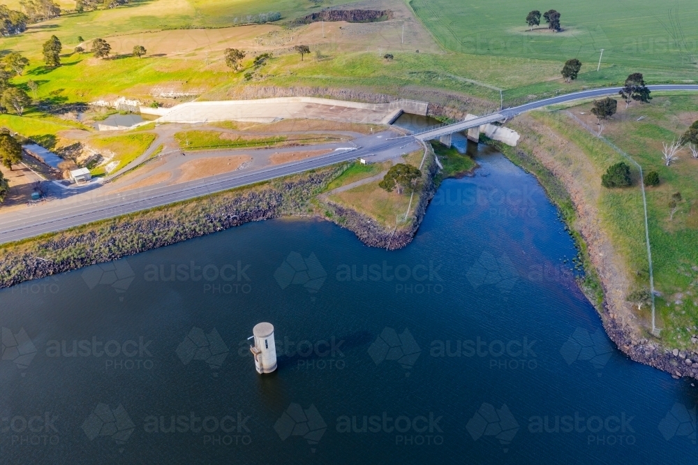 Image of Aerial view of a reservoir with a water tower and a road ...
