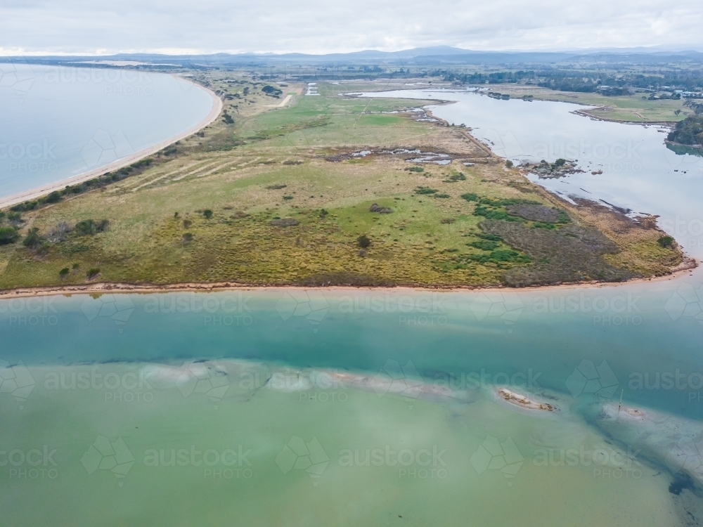 Image of Aerial view of a river flowing around a peninsula from a ...