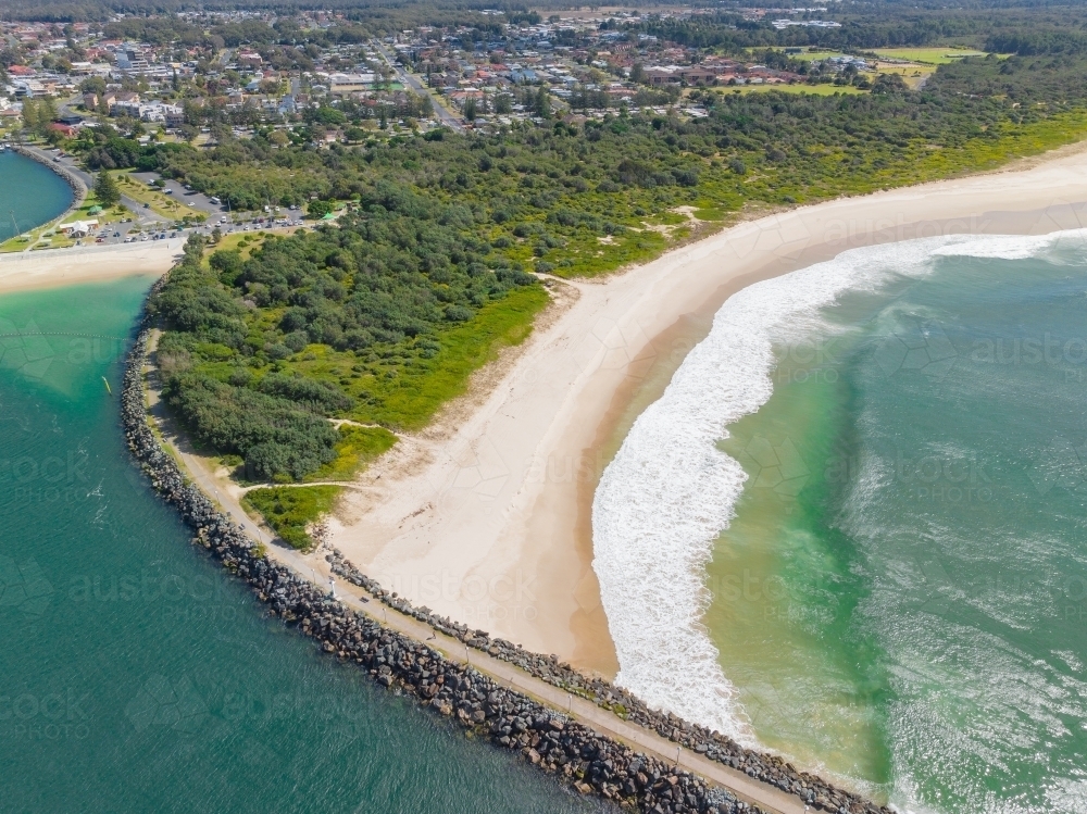 Image of Aerial view of a river flowing out to sea inside a break water ...