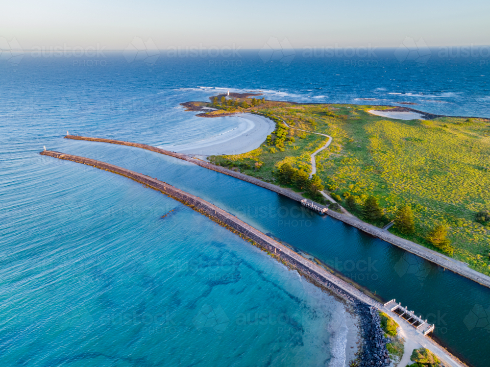 Image of Aerial view of a river mouth flowing out to sea through two ...