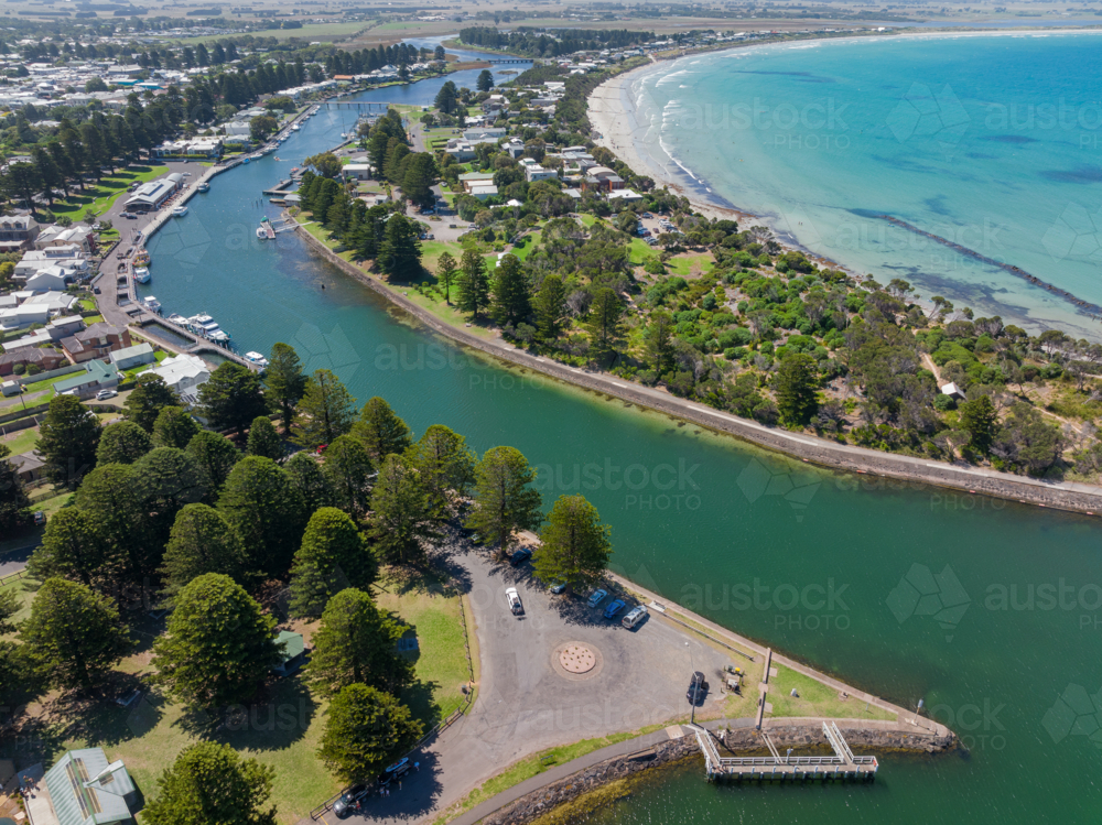 Image of Aerial view of a river running between a coastal town and ...