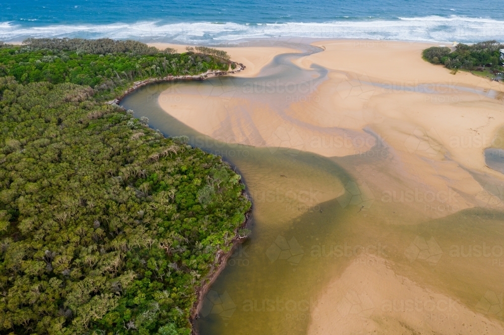 Image of Aerial view of a river winding its way around sand bars and ...
