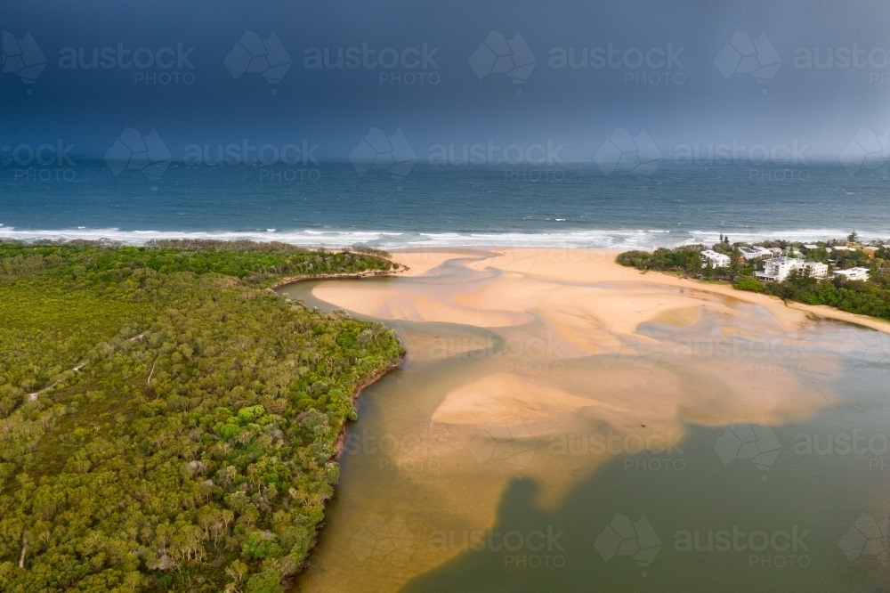 Image of Aerial view of a river winding its way around sand bars and ...