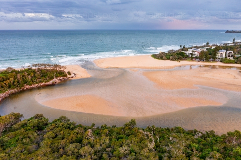 Image of Aerial view of a river winding its way over and around a sandy ...