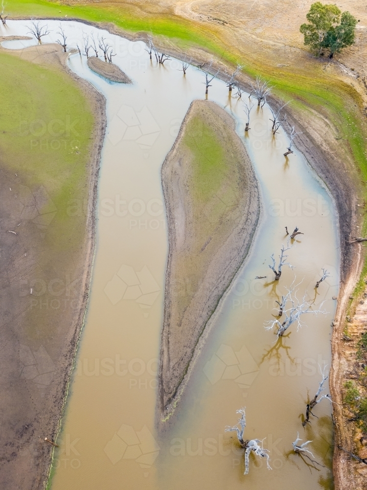 Image of Aerial view of a river winding through farmland - Austockphoto
