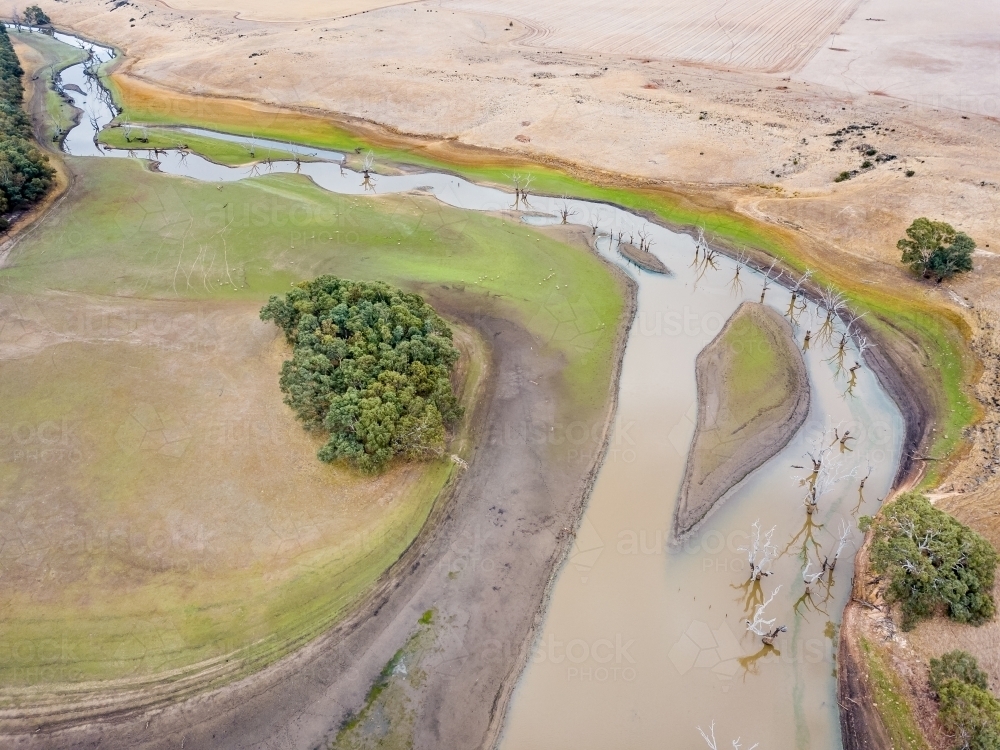 Image of Aerial view of a river winding through farmland - Austockphoto