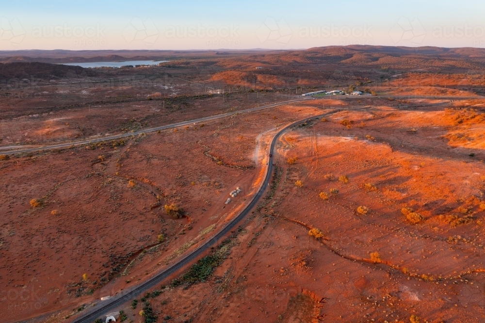 Image of Aerial view of a road and railway line winding through an ...