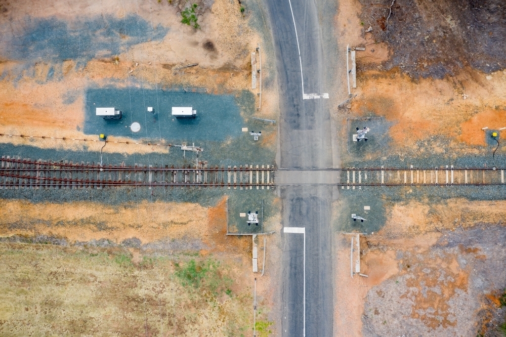 Image of Aerial view of a road crossing a regional railway line ...