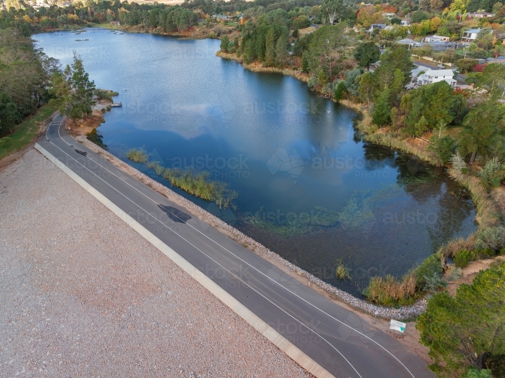 Image of Aerial view of a road over a causeway running next to a lake ...
