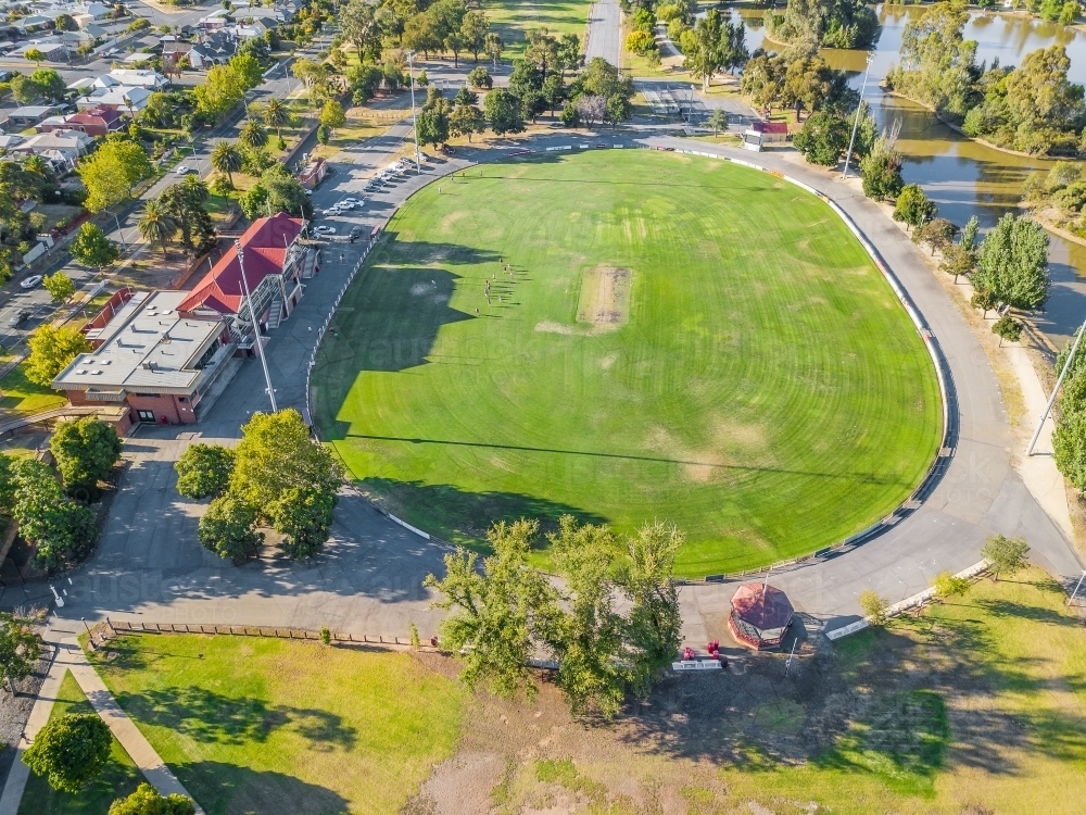 Image of Aerial view of a road surrounding a football oval and ...