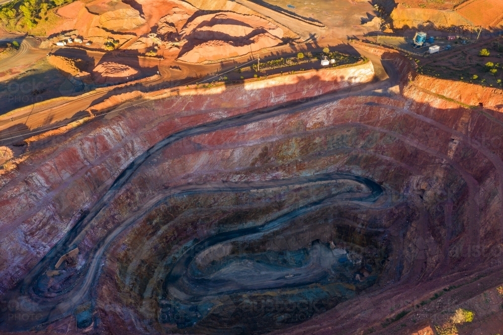 Image of Aerial view of a road winding down into a large open cut mine ...