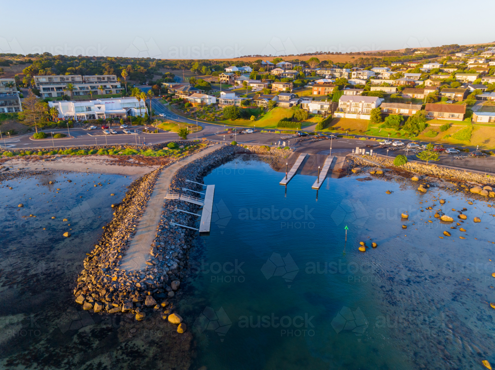 Image of Aerial view of a rocky breakwater alongside a boat ramp at a ...