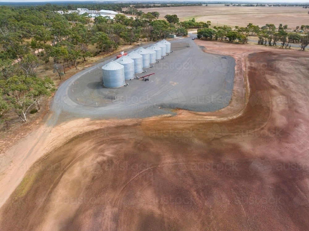 Image of Aerial view of a row of grain silos on the side of a empty ...
