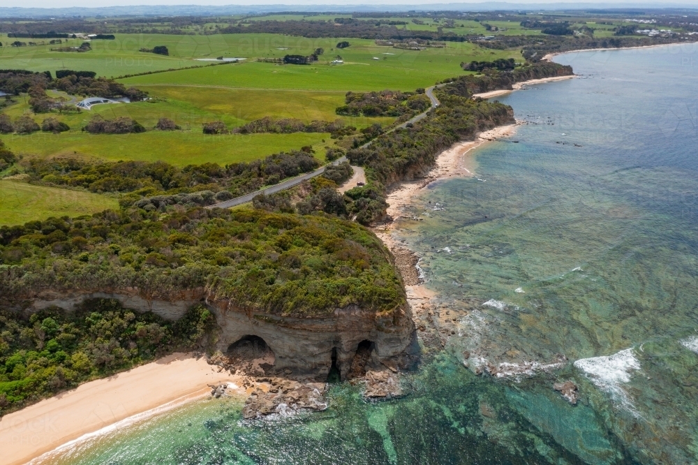 Image of Aerial view of a rugged coastline with caves and beaches and ...