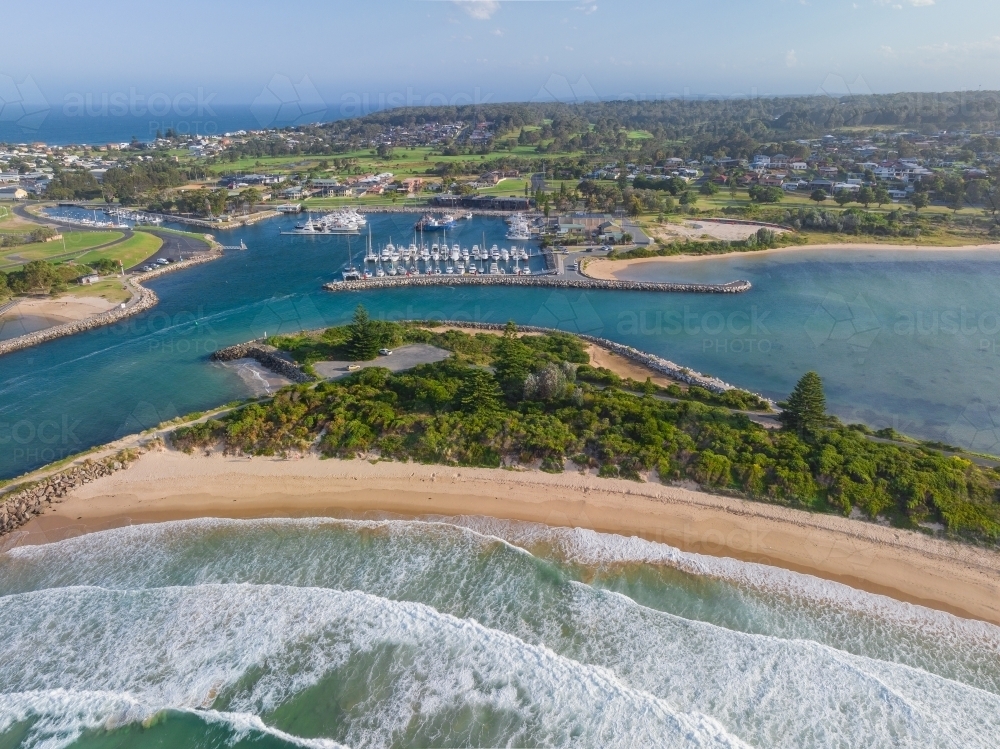 Image of Aerial view of a sandy beach in front of a marina and inland ...
