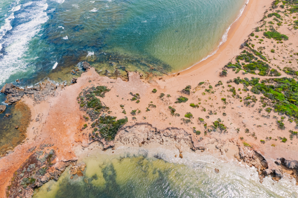 Image of Aerial view of a sandy coastal point above a rocky Headland ...