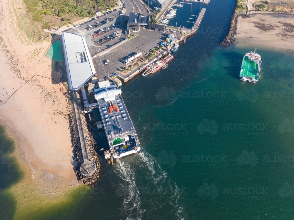 Image of Aerial view of a sea ferry at a transport terminal near a ...
