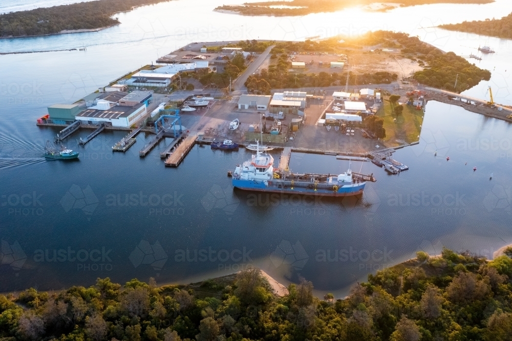 Image of Aerial view of a ship at a wharf alongside a ship repair dock ...