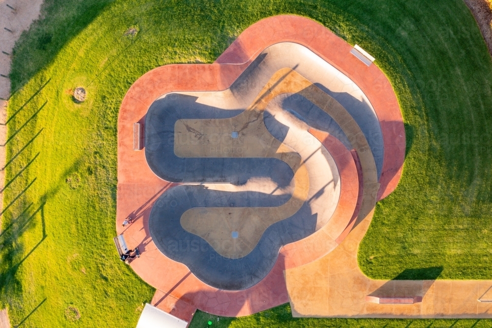 Image of Aerial view of a skate bowl surrounded by a grassy area ...