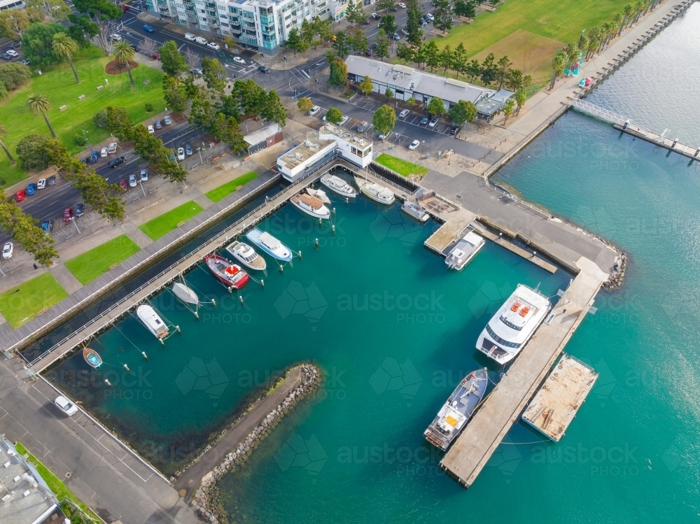 Image of Aerial view of a small boat marina, alongside green coastal ...