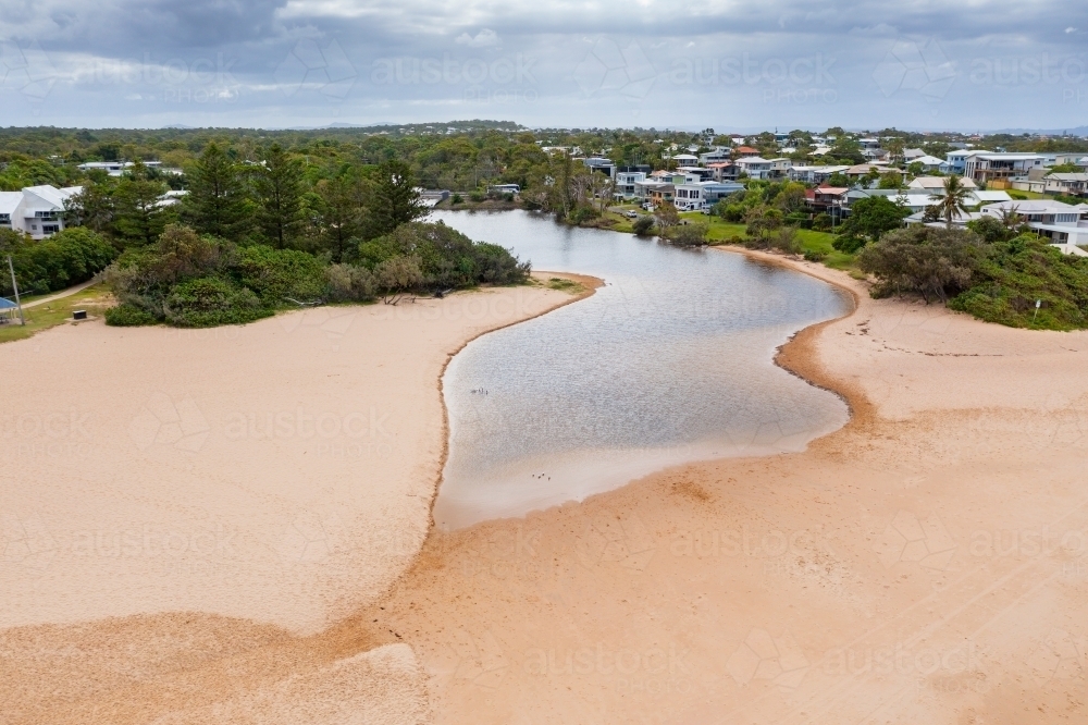 Image of Aerial view of a small creek cut off by a sand on a beach ...