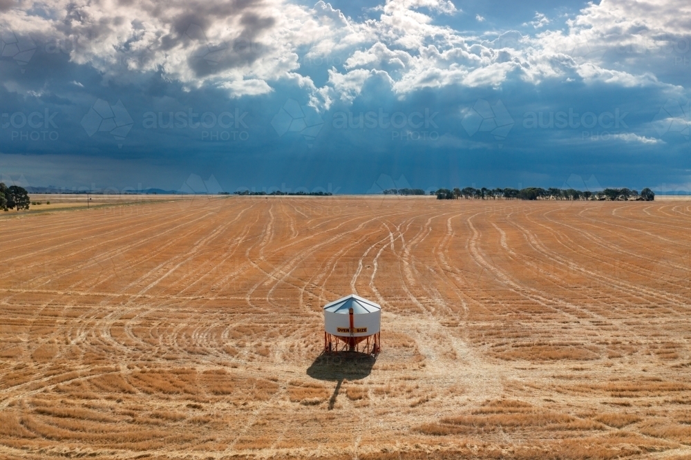 Image of Aerial view of a solitary field bin sitting in a large barren ...
