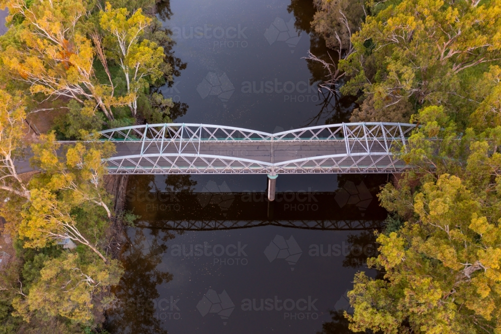 Image of Aerial view of a steel arch bridge over a river with gum trees ...
