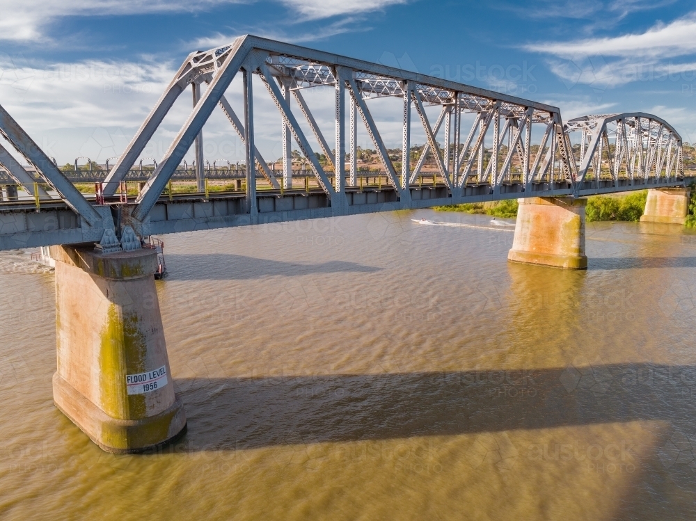 Image of Aerial view of a steel bridge crossing a wide brown river ...
