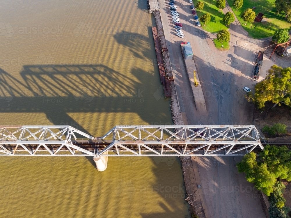 Image of Aerial view of a steel bridge over a wharf area and a wide ...