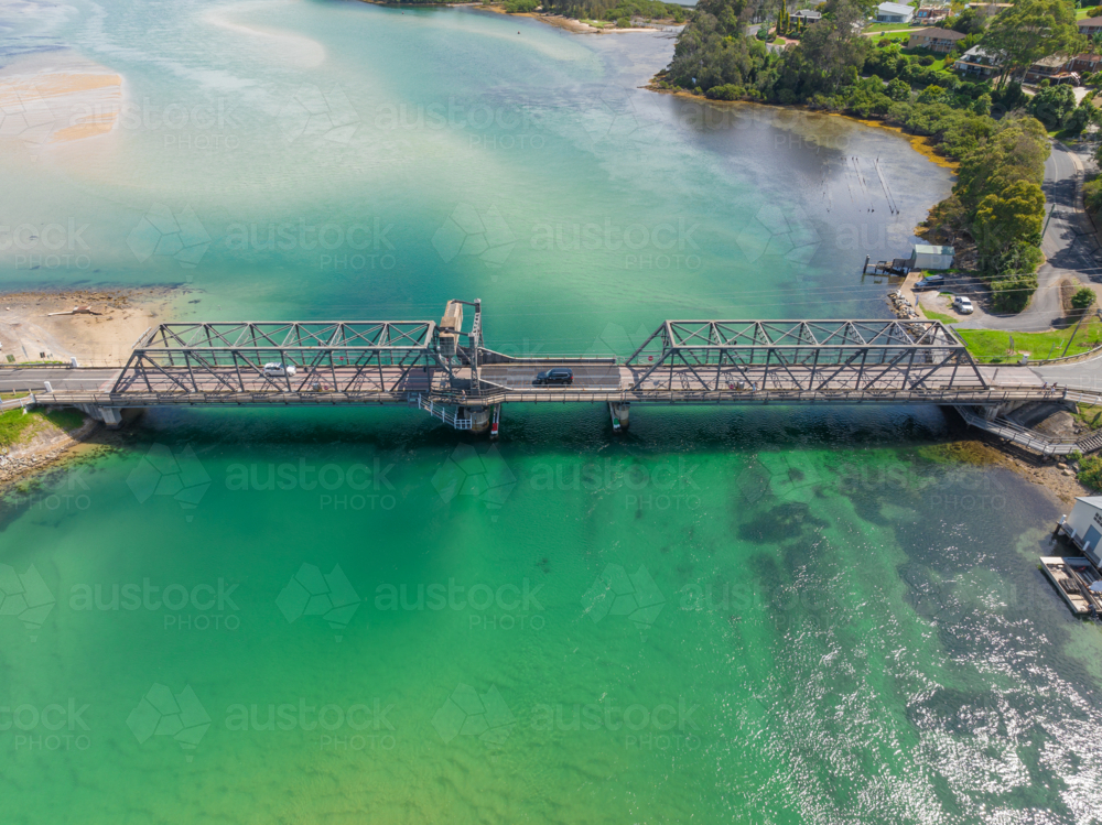 Image of Aerial view of a steel truss bridge of a torquoise coastal ...