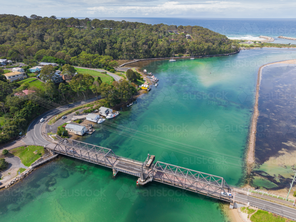 Image of Aerial view of a steel truss bridge of a torquoise coastal ...