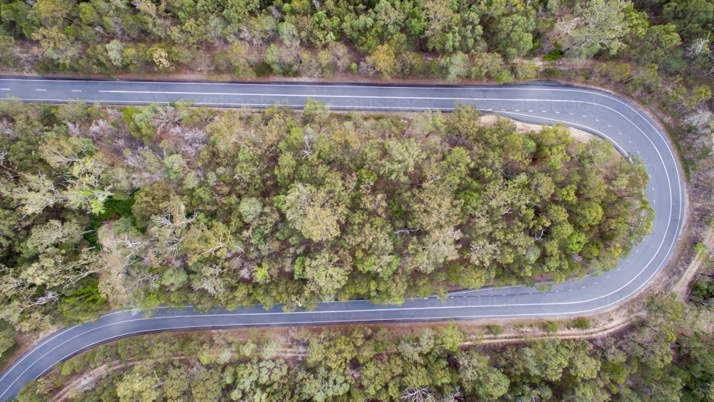Image of Aerial view of a switchback road. - Austockphoto