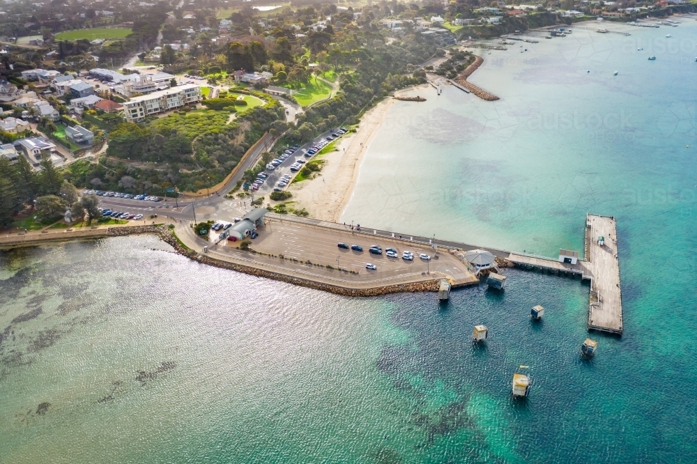 Image of Aerial view of a T shaped jetty out over the ocean - Austockphoto