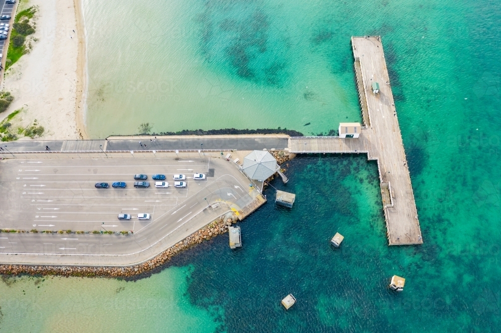 Image of Aerial view of a T shaped jetty out over the ocean - Austockphoto