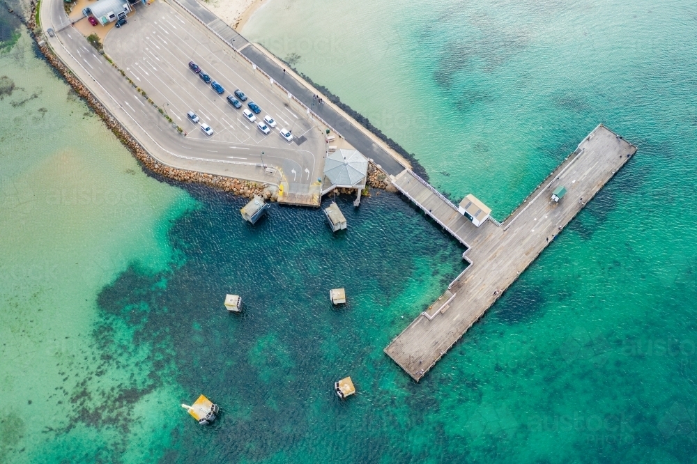 Image of Aerial view of a T shaped jetty out over the ocean - Austockphoto