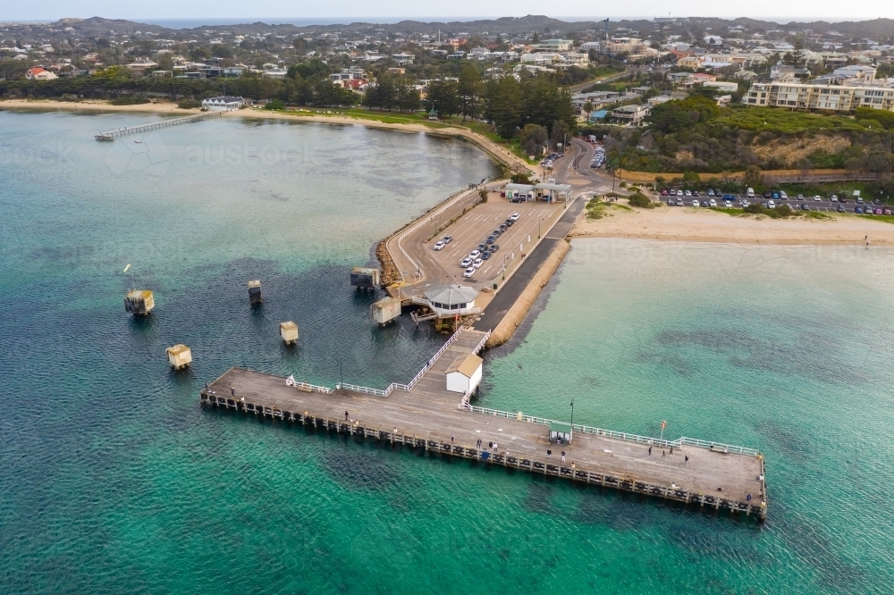 Image of Aerial view of a T shaped jetty out over the ocean - Austockphoto