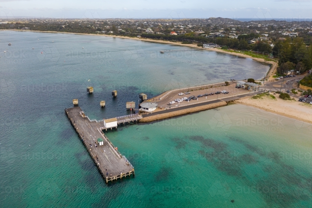 Image of Aerial view of a T shaped jetty out over the ocean - Austockphoto