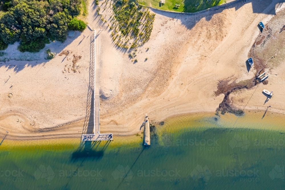 Image of Aerial view of a T shaped jetty over a beach to the shoreline ...
