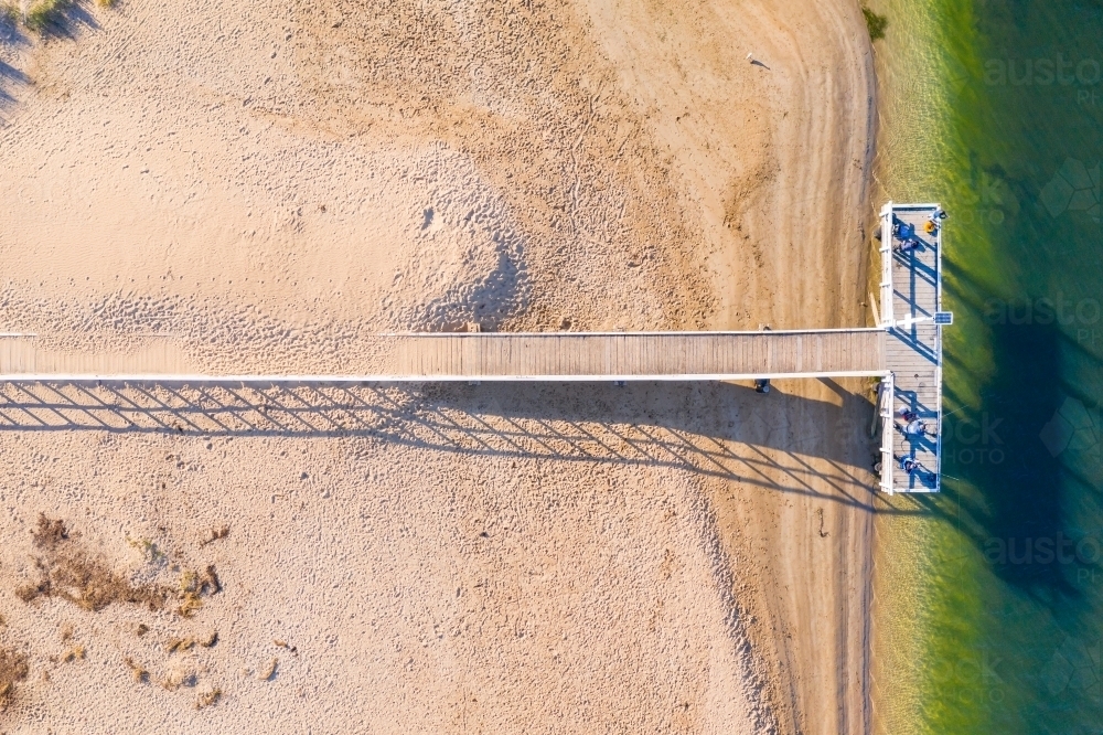Image of Aerial view of a T shaped jetty over a beach to the shoreline ...