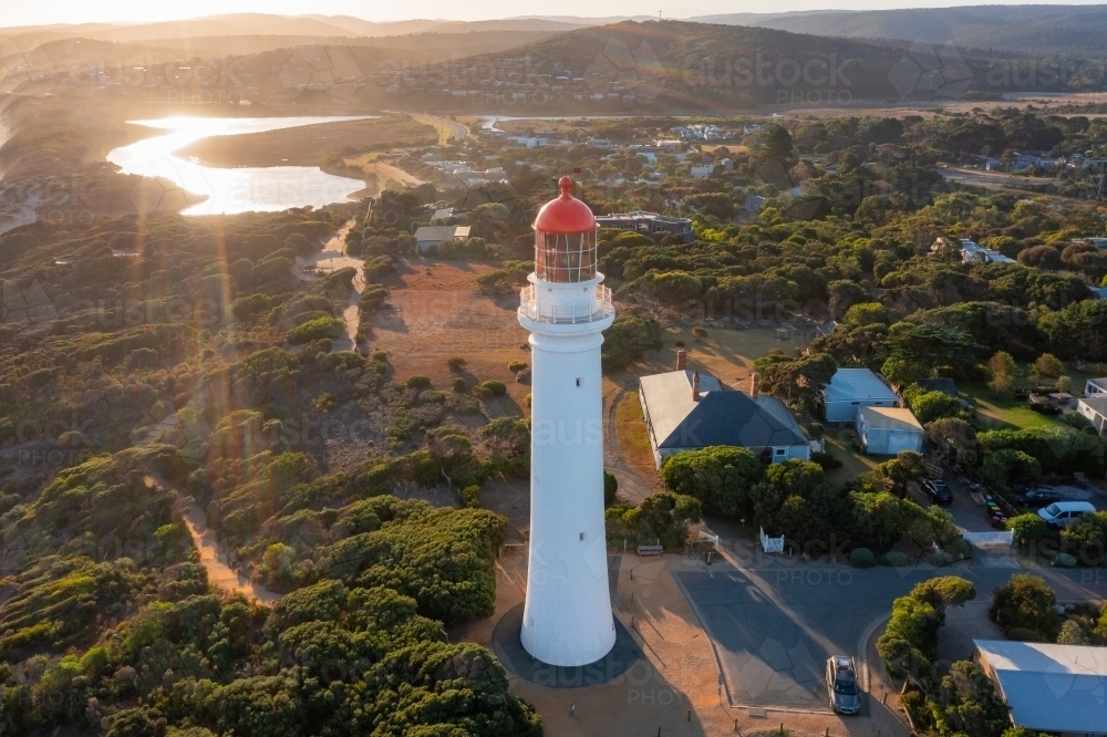 Image of Aerial view of a tall white lighthouse high on a hill top in ...