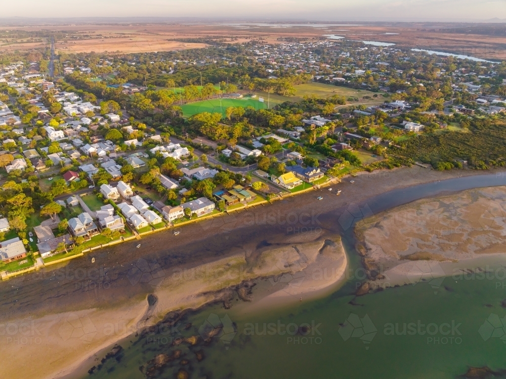 Image of Aerial view of a township on the bank of a coastal river ...