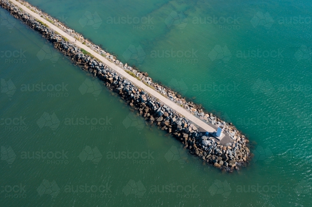 Image of Aerial view of a warning beacon on the end of a rocky ...