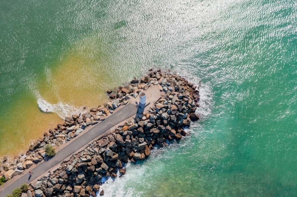 Image of Aerial view of a warning beacon on the end of a rocky ...