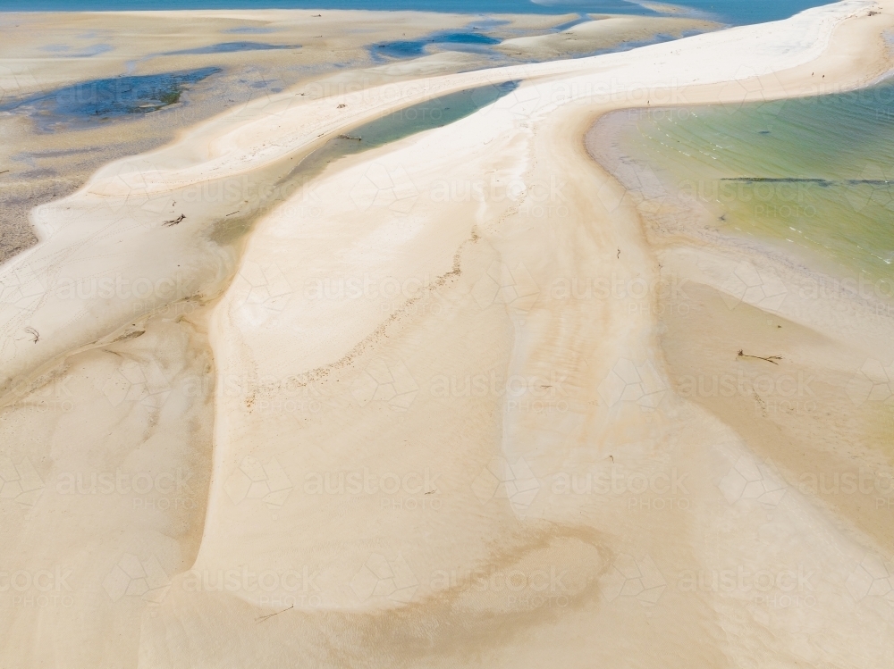 Image of Aerial view of a white sand bars surrounded buy pools of blue ...