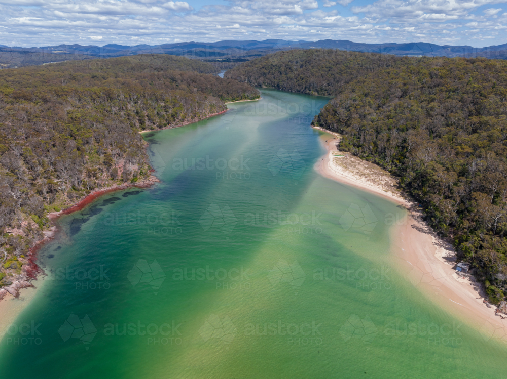 Image of Aerial view of a wide coastal river with forest on both banks ...